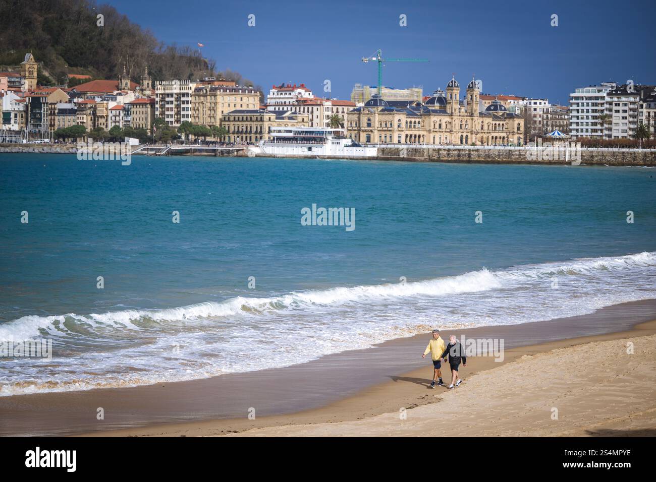 People walking along La Concha beach in winter in San Sebastian, Basque ...
