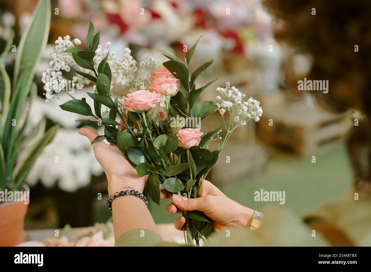 High angle shot of small but elegant bouquet of bush roses, gypsophila ...