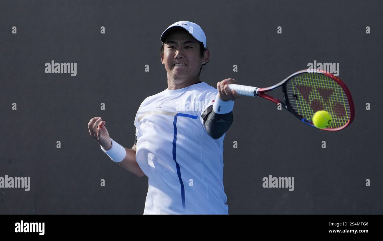 Yoshihito Nishioka of Japan plays a forehand return to Aziz Dougaz of ...