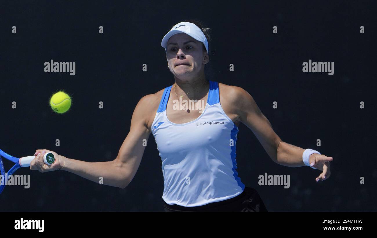 Magda Linette of Poland plays a forehand return to Moyuka Uchijima of ...