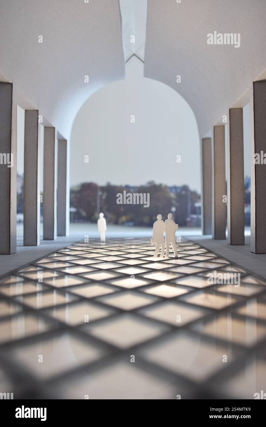 A detailed architectural model with figures shows a spacious arcade ...