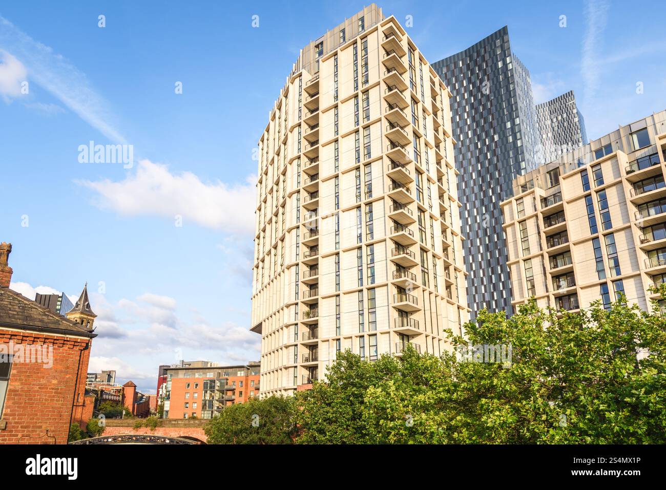 Modern block of flats alongside renovated traditional brick buildings ...