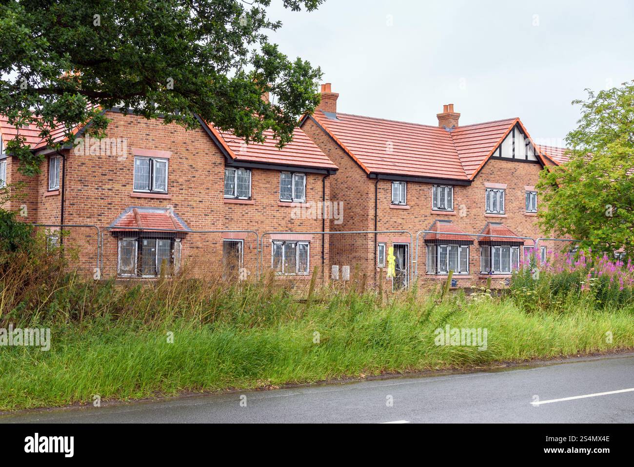 Brick semi-detached houses under construction in a housing development ...