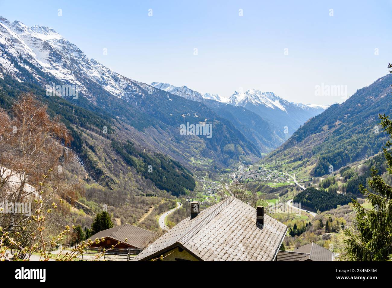 Mountain valley overlooked by snow-capped peaks in the Swiss Alps on a ...