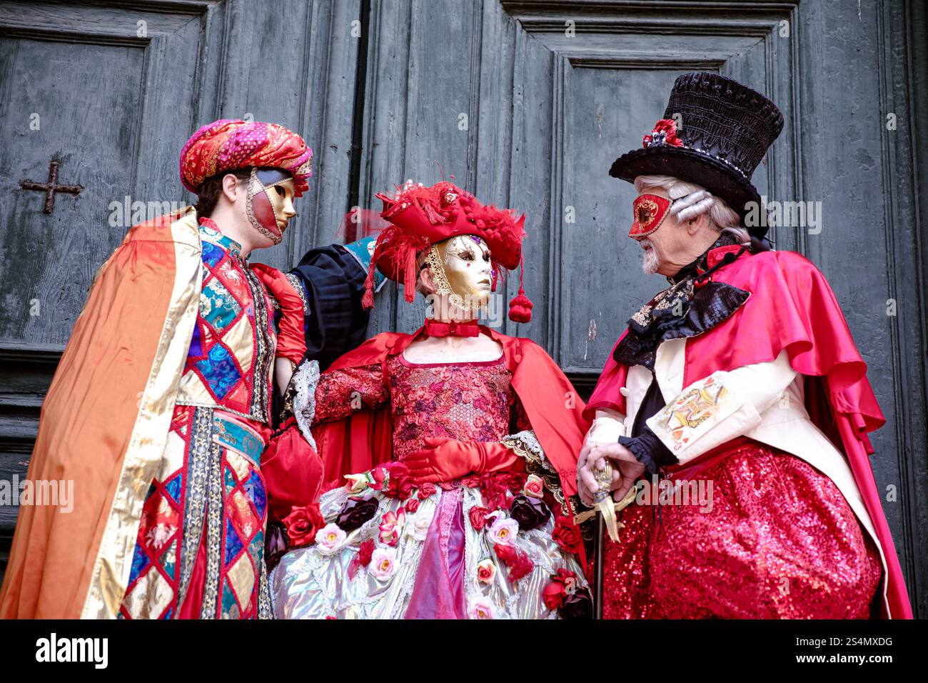 Colorful venetian masks and costumes in festive street gathering Stock ...