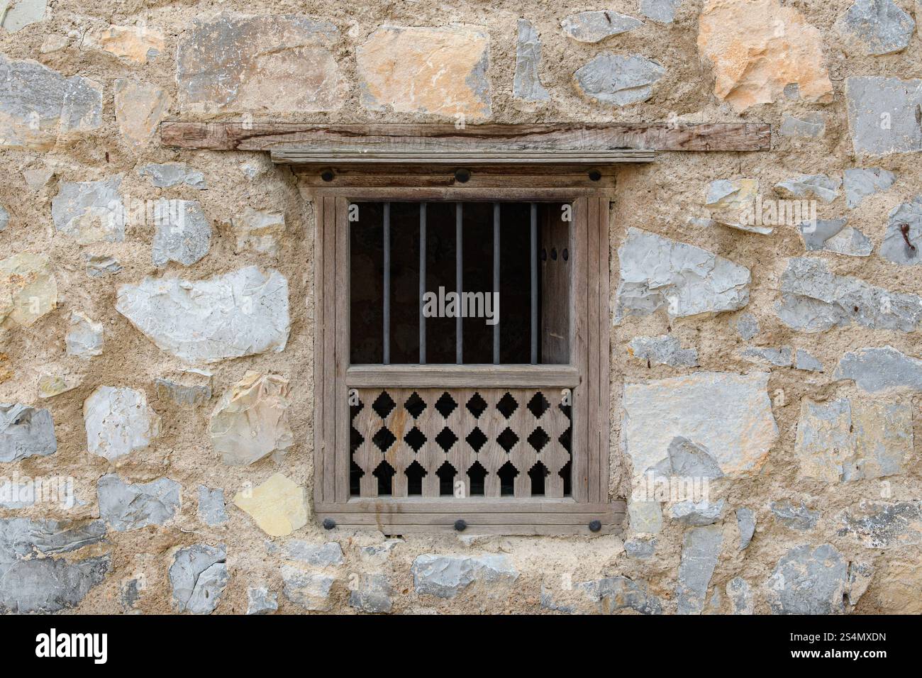 Khasab, Oman - January 1, 2025: A rustic window with wooden bars and ...