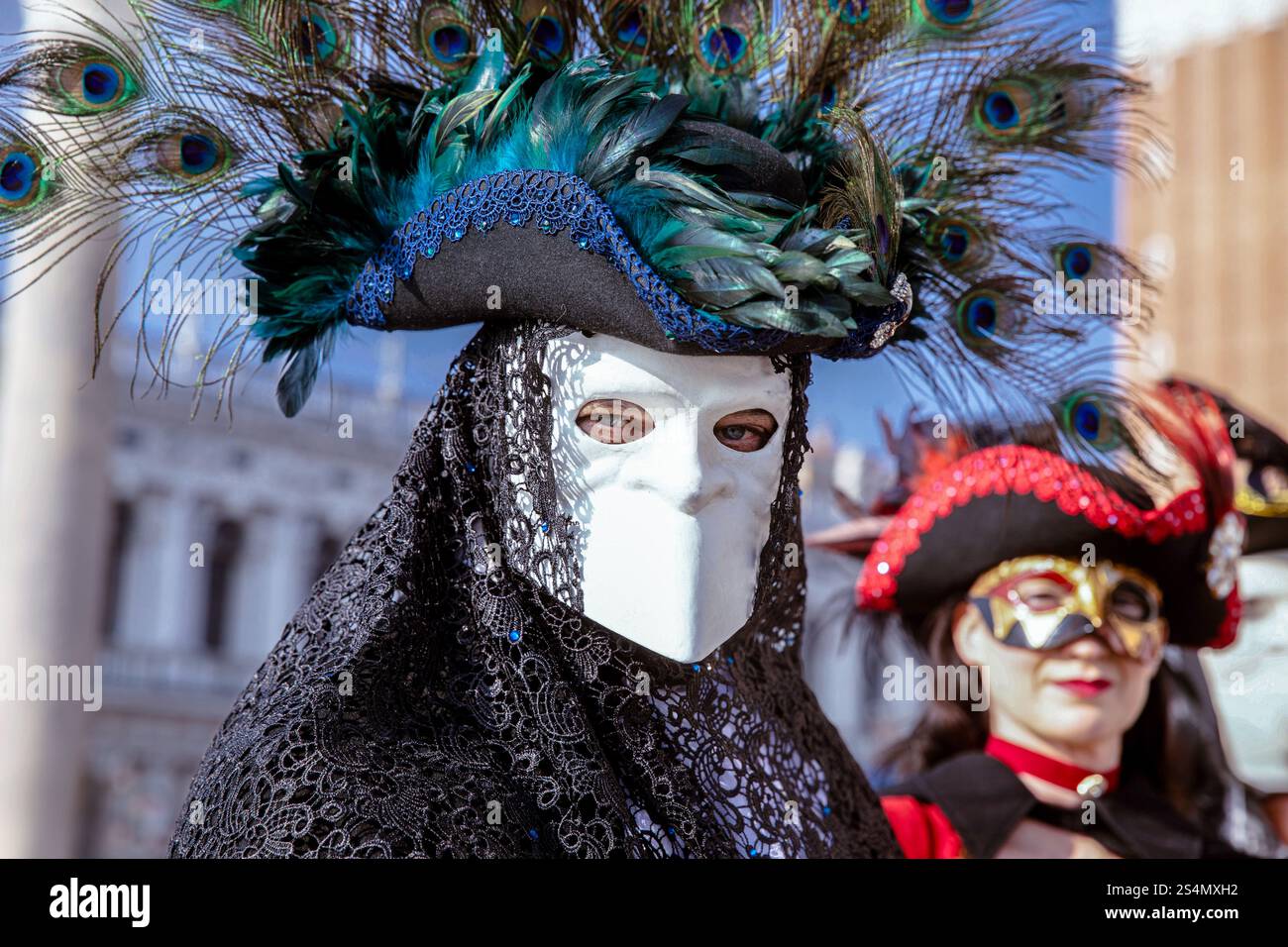 Caucasian adults in elaborate masks and costumes at festival Stock ...