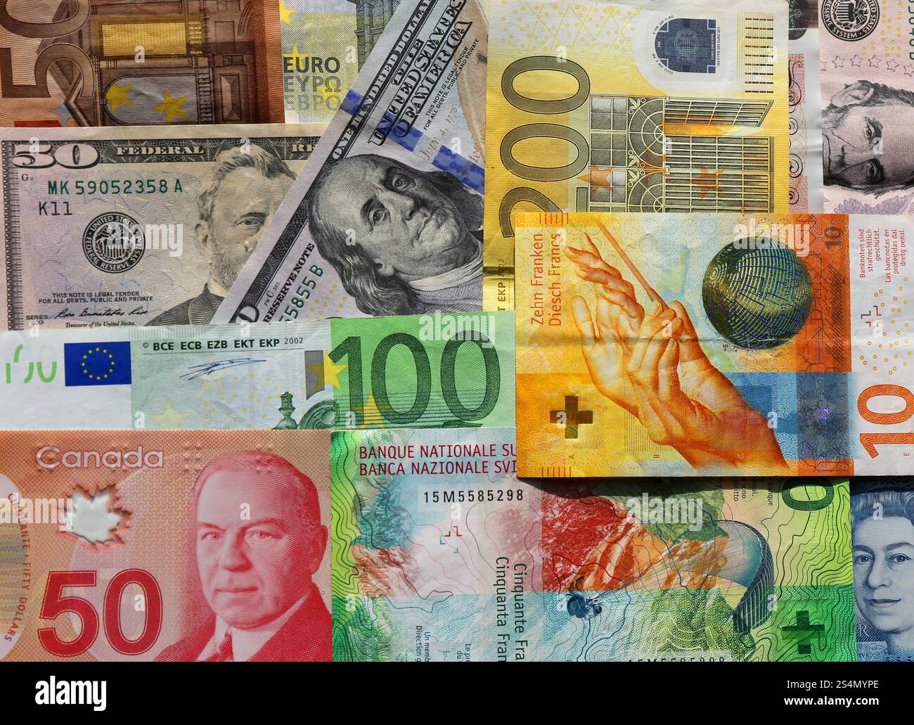 Colorful Canadian, US Dollar, Euro, Swiss Franc and Pound Banknotes ...
