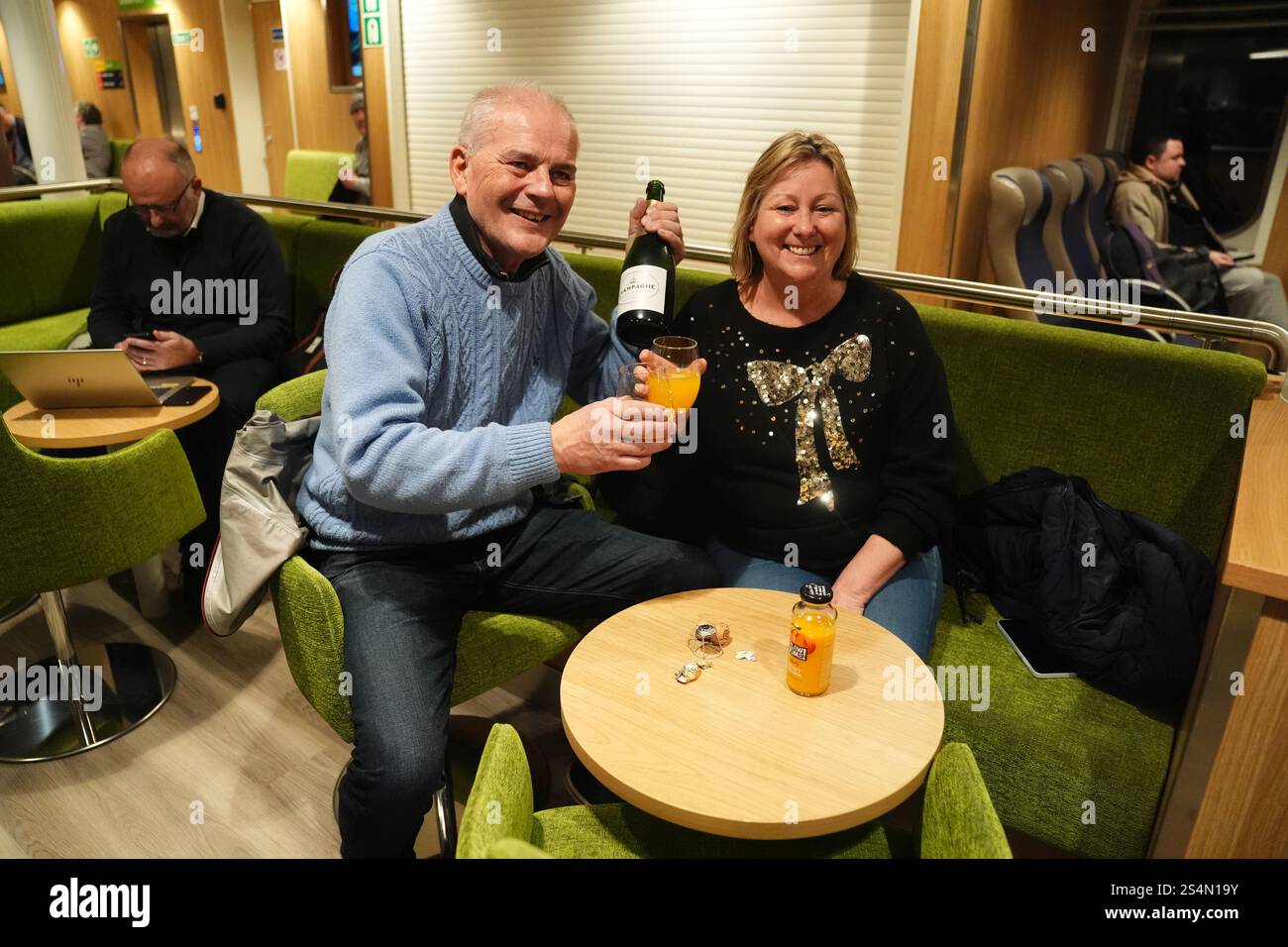 Passengers enjoy champagne onboard The Glen Sannox ferry as it journeys ...