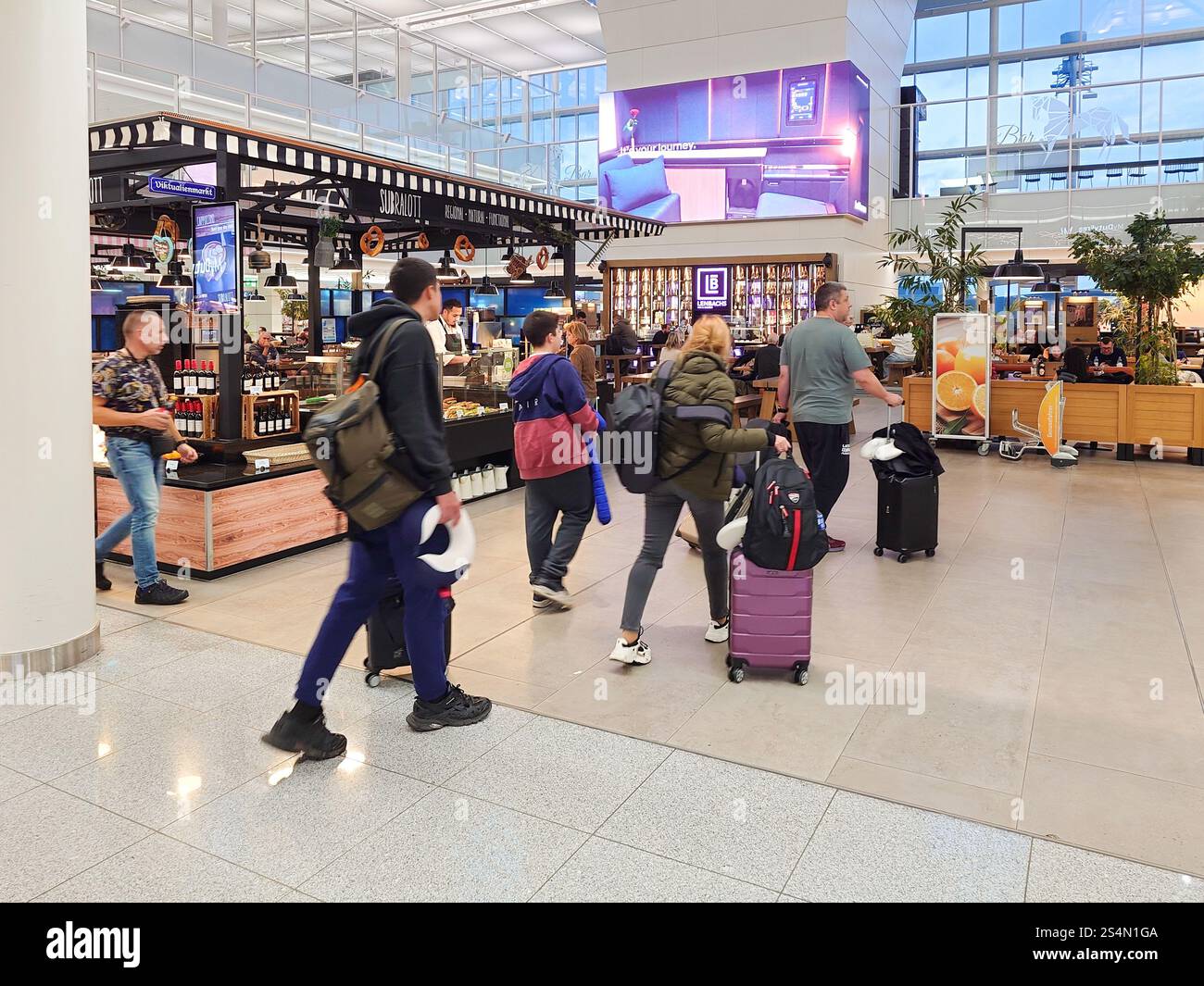 27-12-2024 Munich International Airport, Germany. People walking and ...