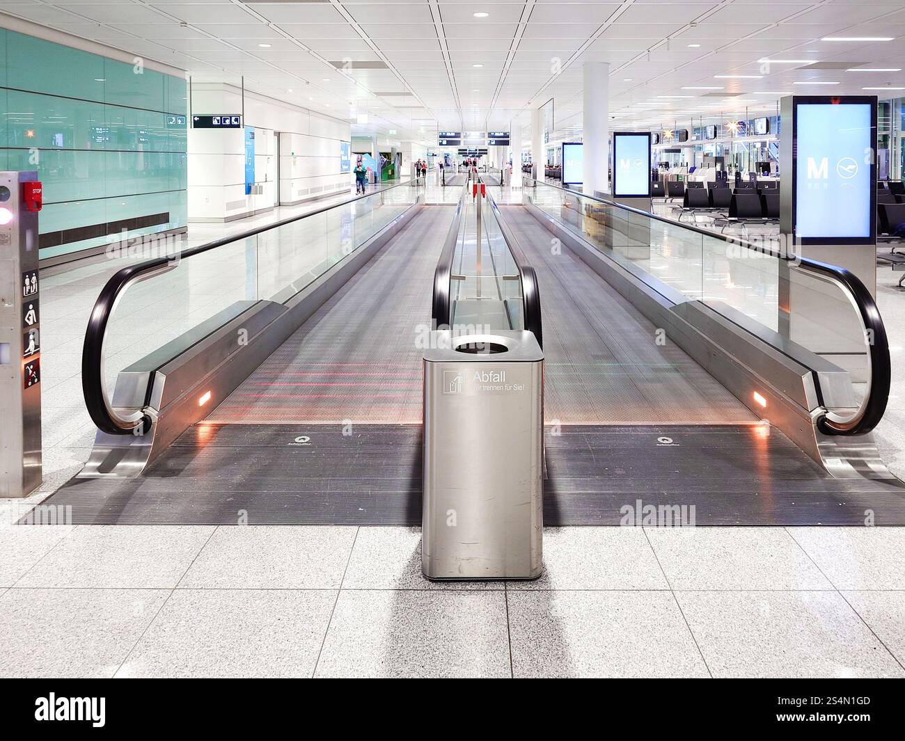 27-12-2024 Munich International Airport, Germany. Long rolling walkways ...