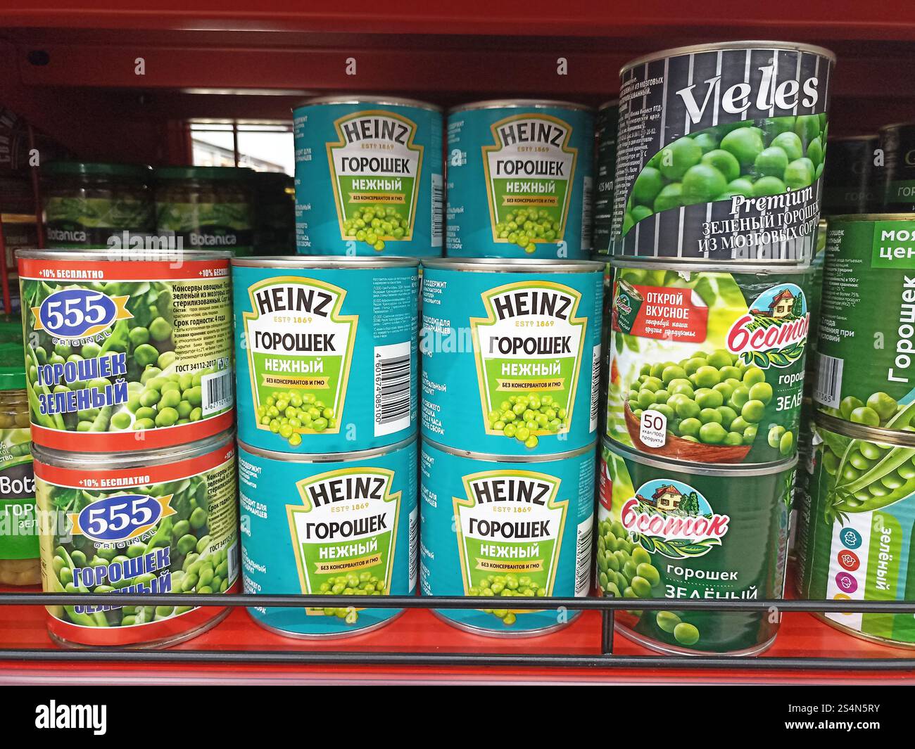 Assorted canned peas on store shelf with various brands and labels ...