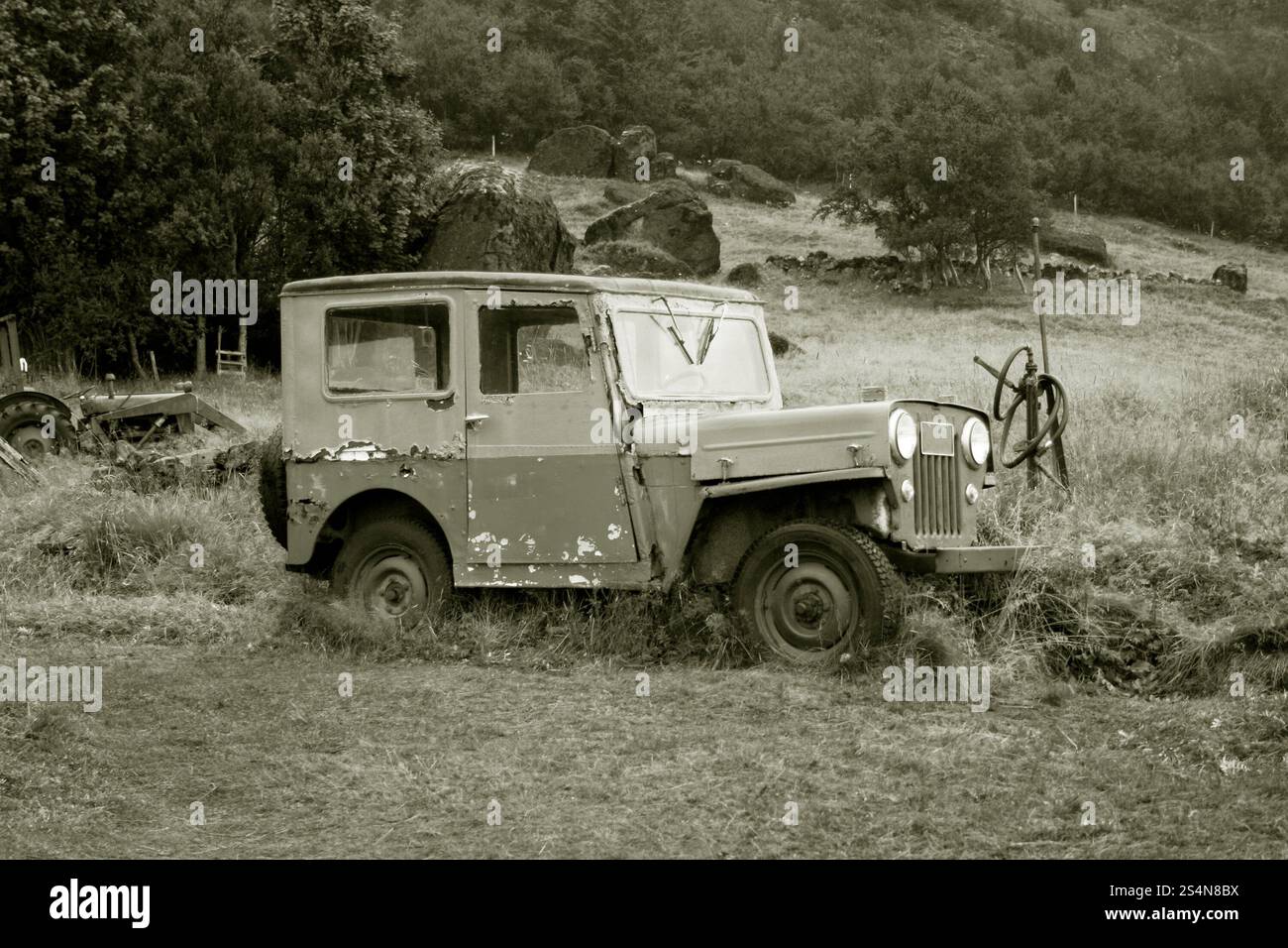 old and weathered car in yellow and red in rural landscape Stock Photo ...