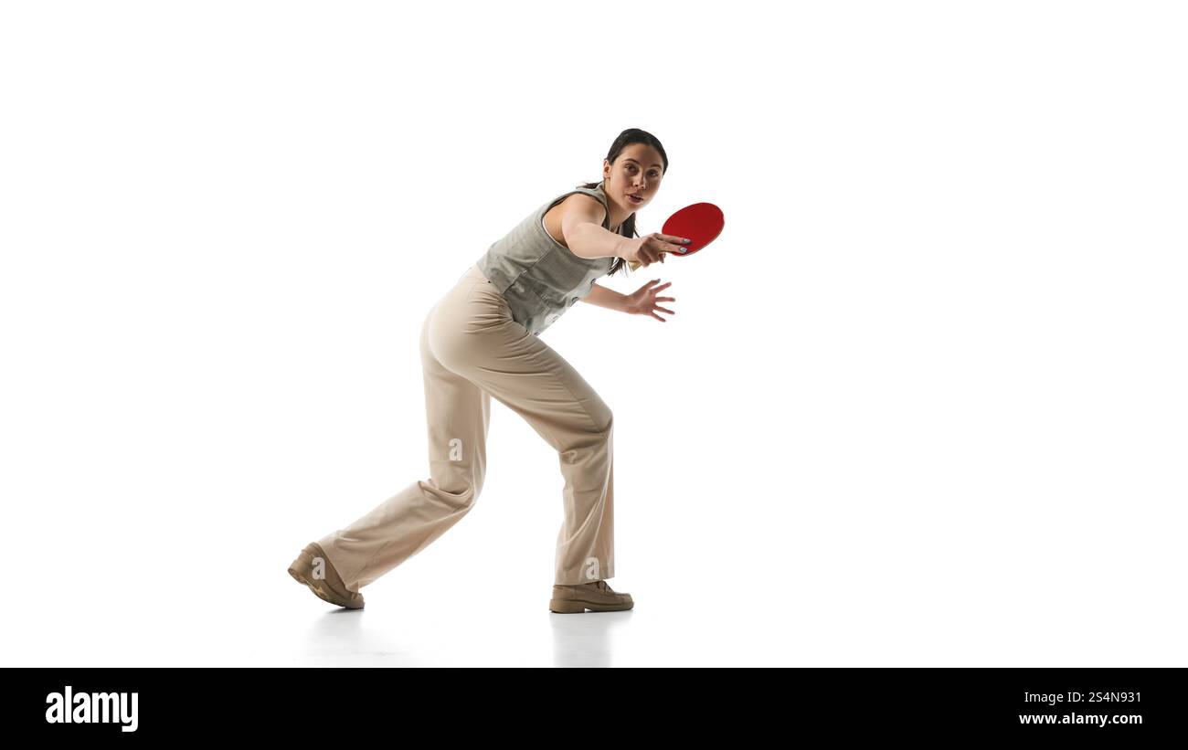 Woman dressed formalwear holding red ping-pong paddle ready to play ...
