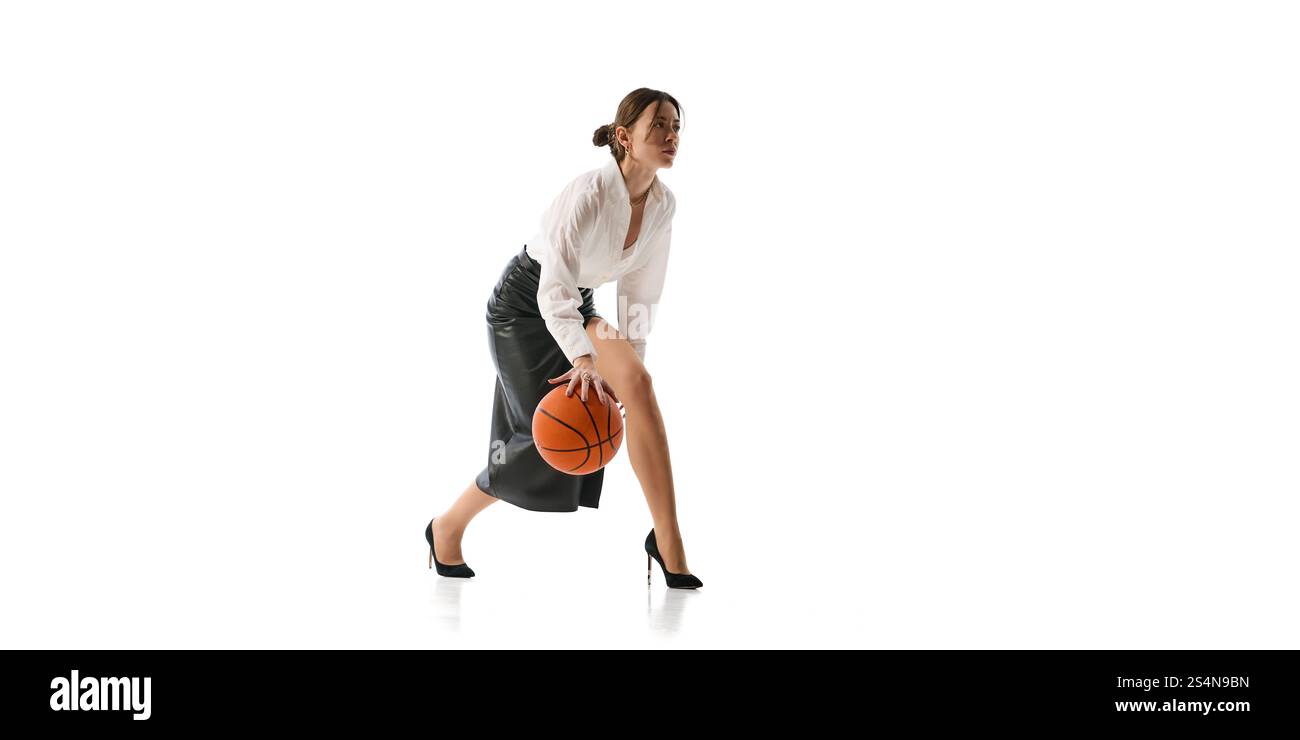 Woman dribbling basketball in heels, reflecting balance between ...