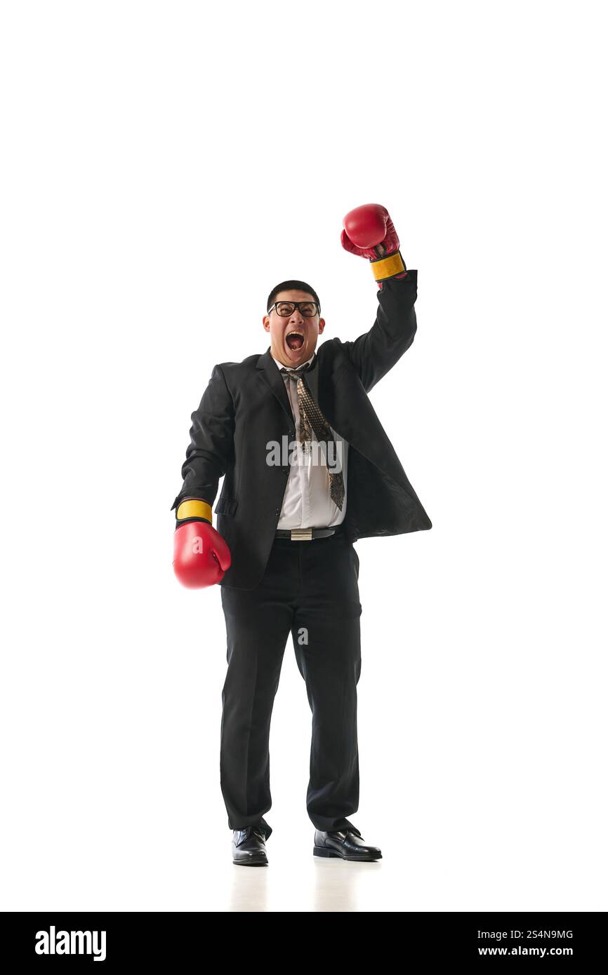 Standing tall and triumphant, man raises hand in celebration ...