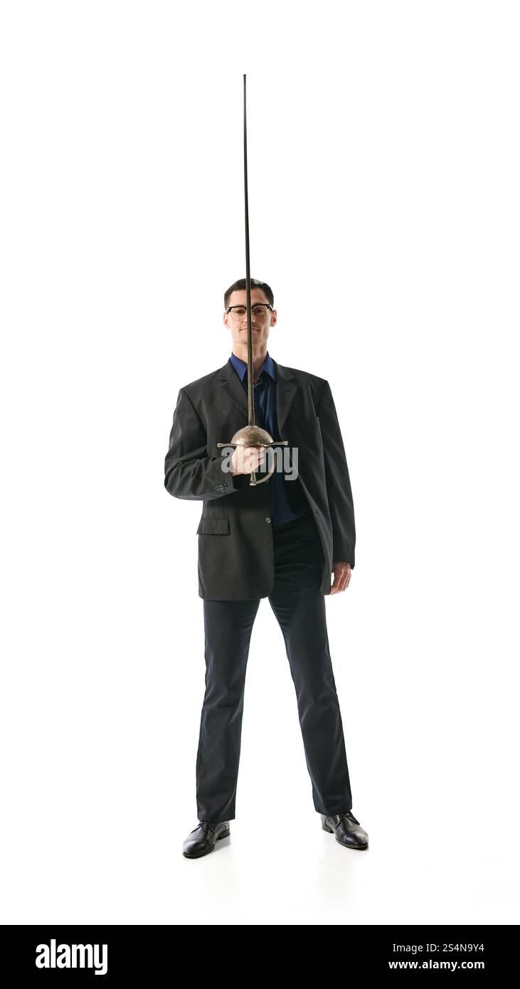 Businessman standing confidently with fencing sword, representing ...