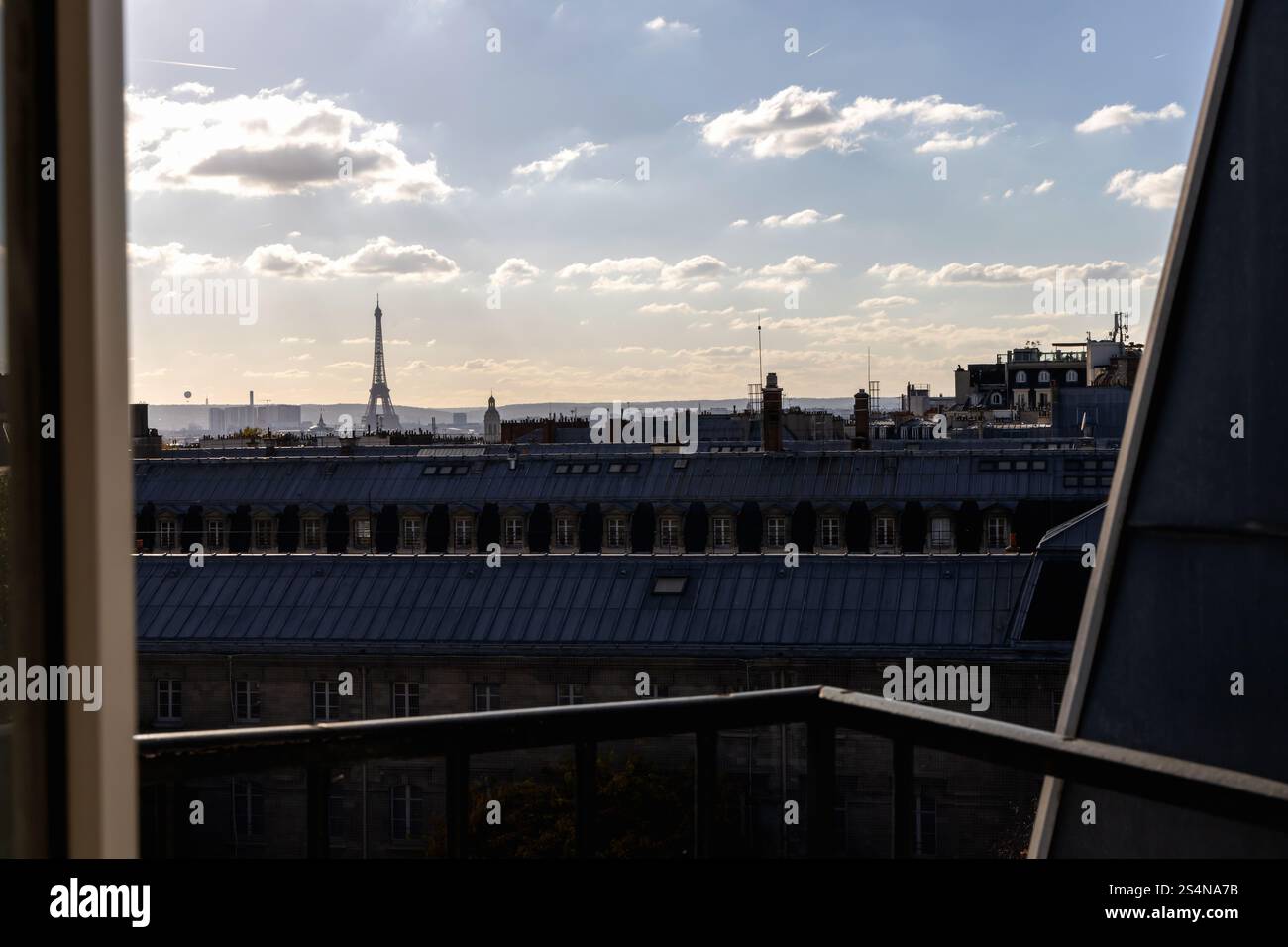 Open window with romantic view of rooftops and Eiffel Tower in Paris ...