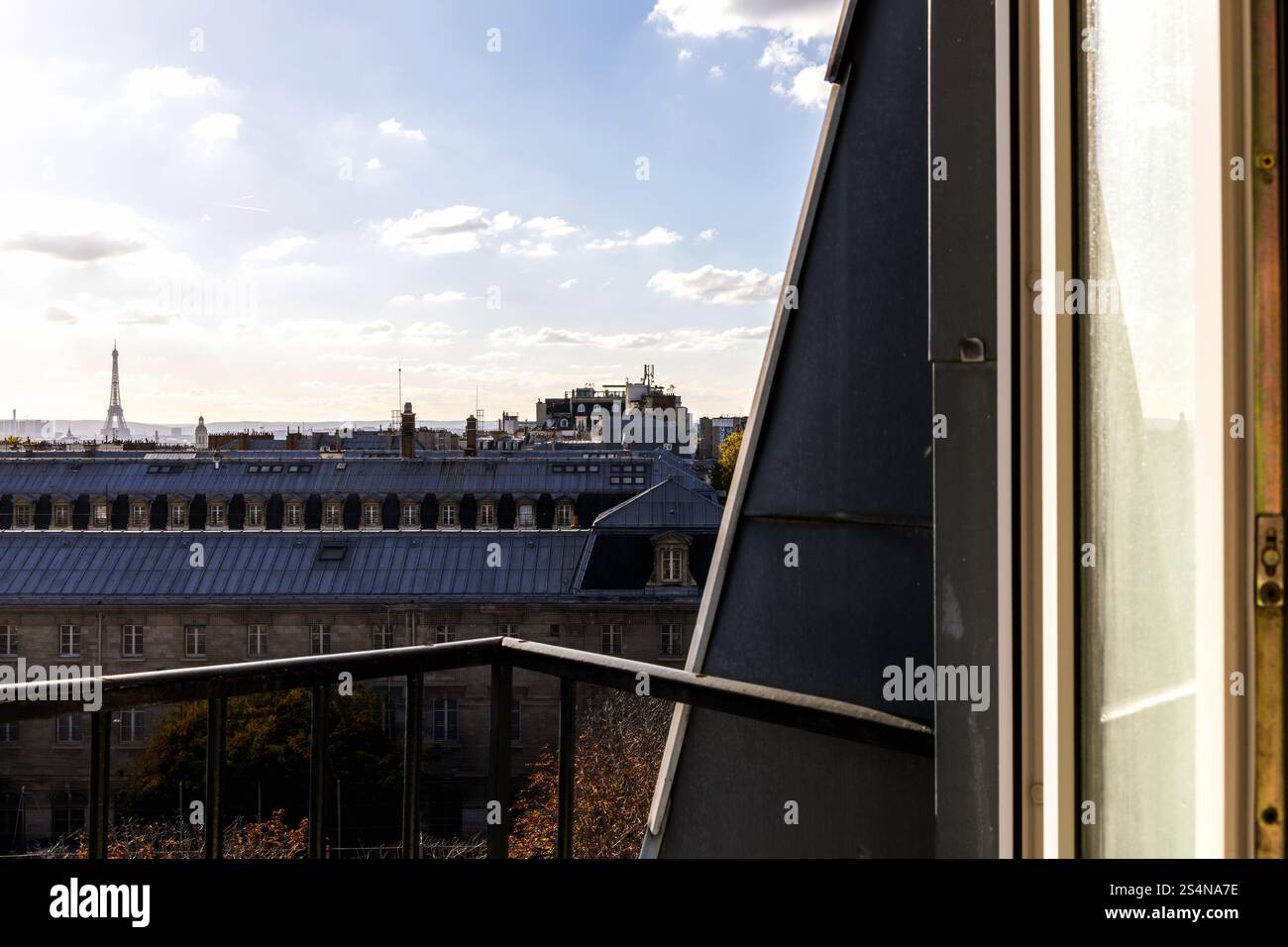 Open window with romantic view of rooftops and Eiffel Tower in Paris ...