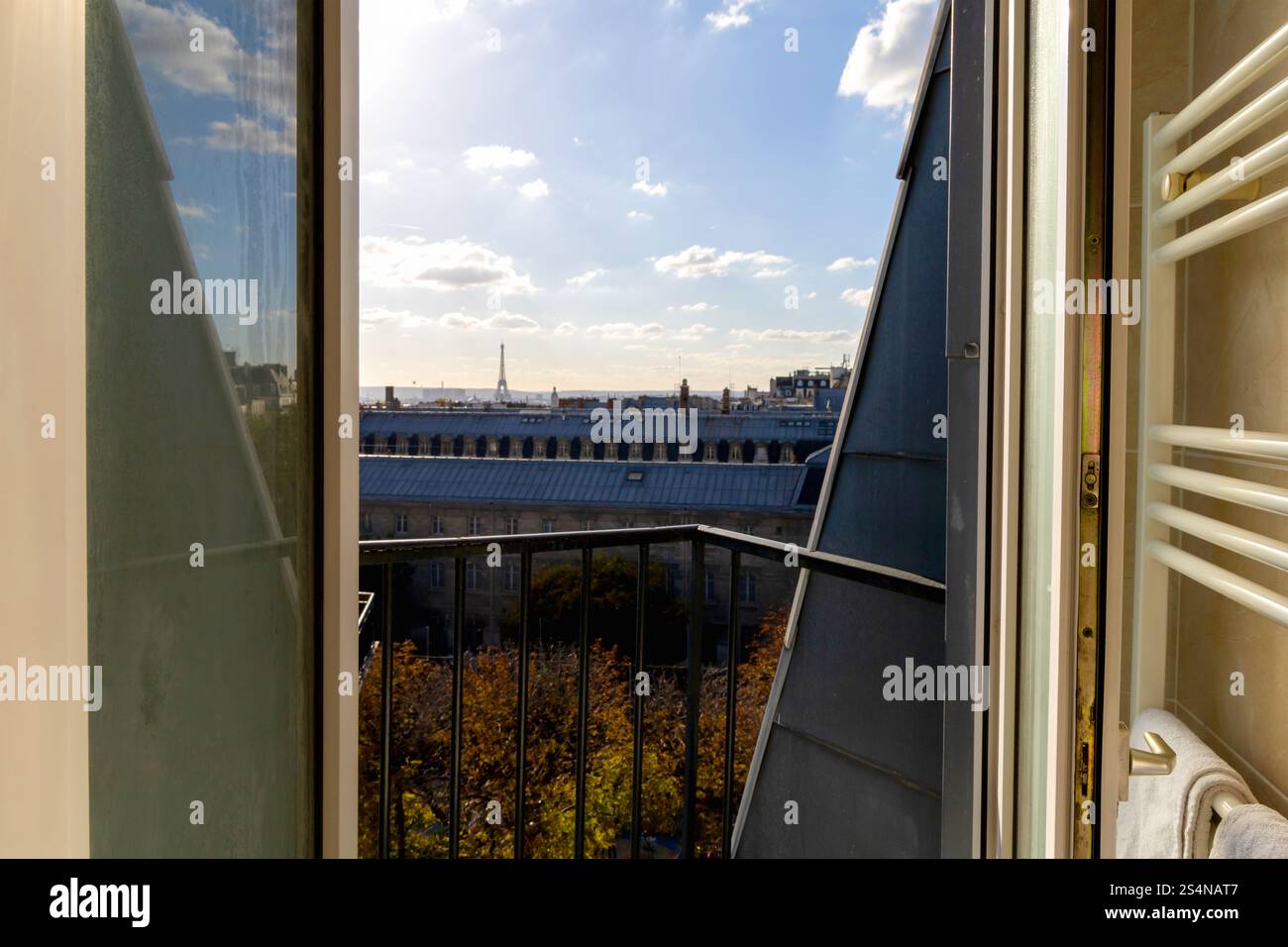 Open window with romantic view of rooftops and Eiffel Tower in Paris ...