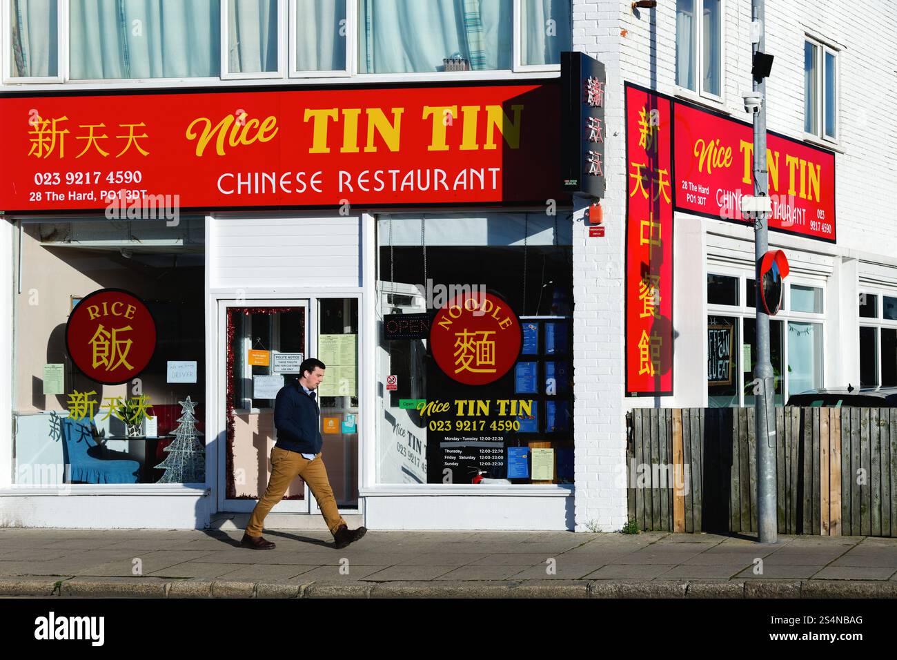 A lone male figure walking past the TinTin Chinese restaurant on The ...