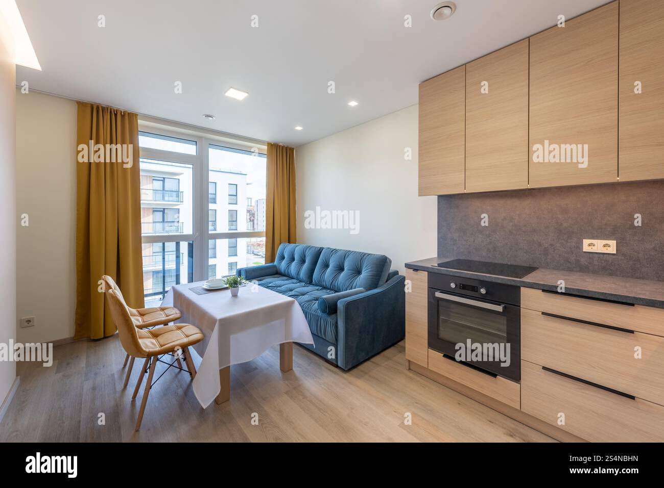 Bright and cozy apartment interior featuring a comfortable sofa, dining ...