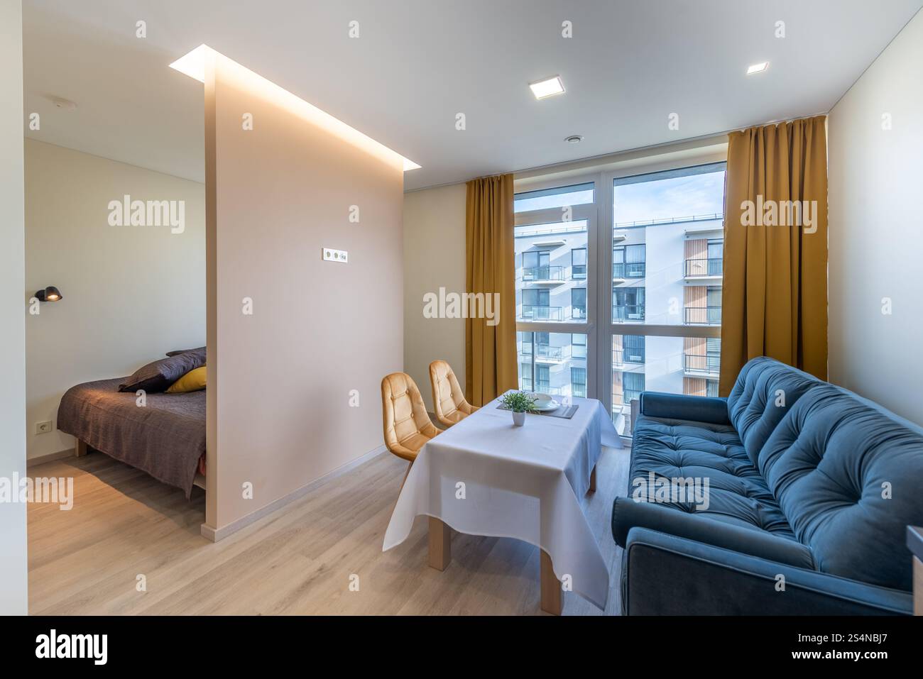 Cozy studio apartment featuring a compact living space with a sofa ...