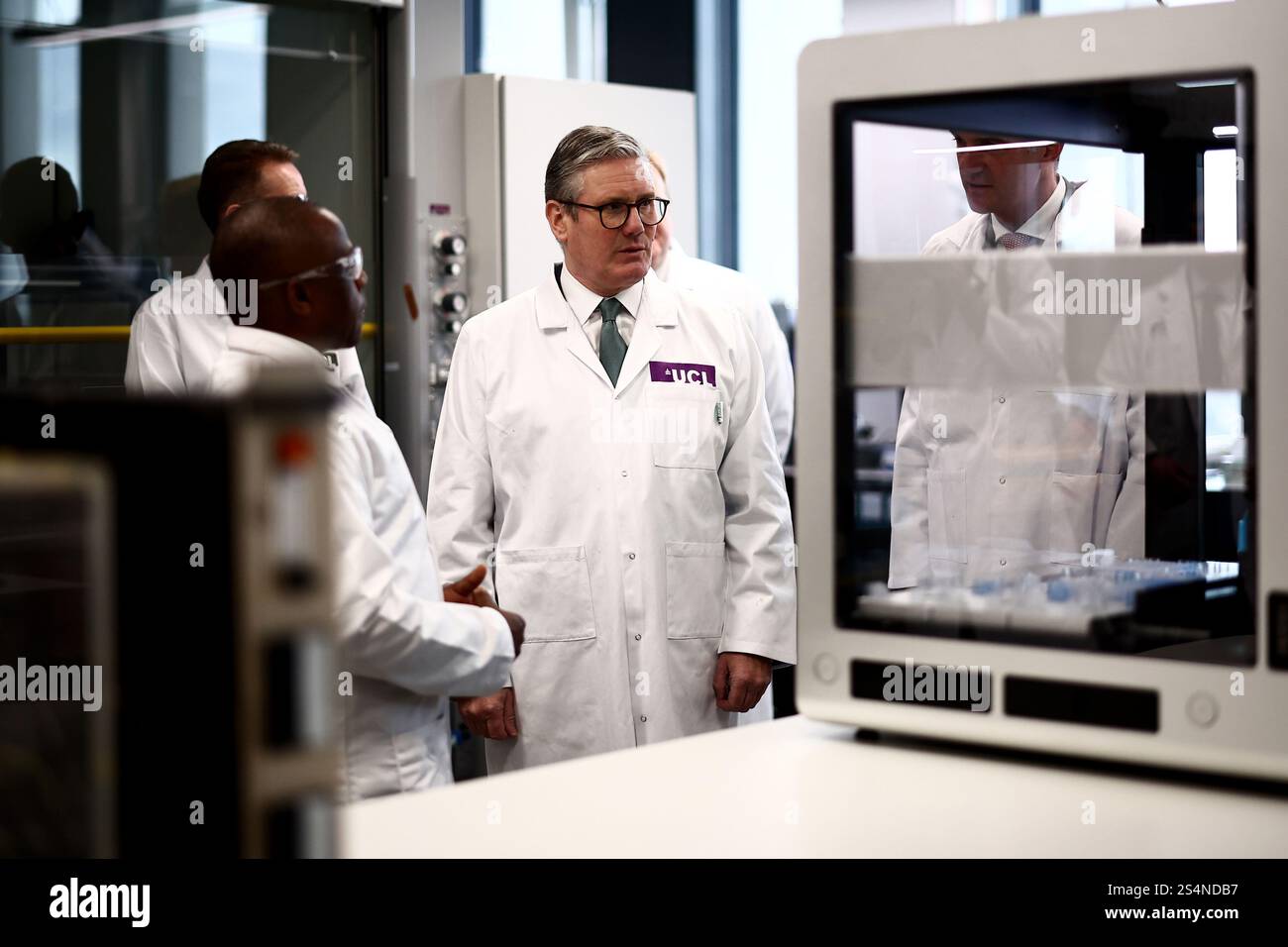 Prime Minister Sir Keir Starmer looks at a liquid handling robot while ...