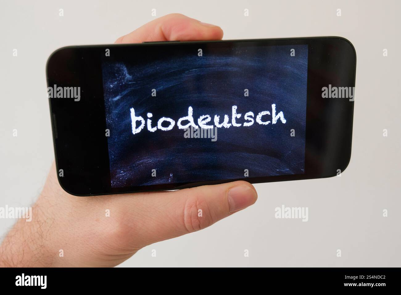 Hand with mobile phone with the unword of the year 2024 bio-German ...