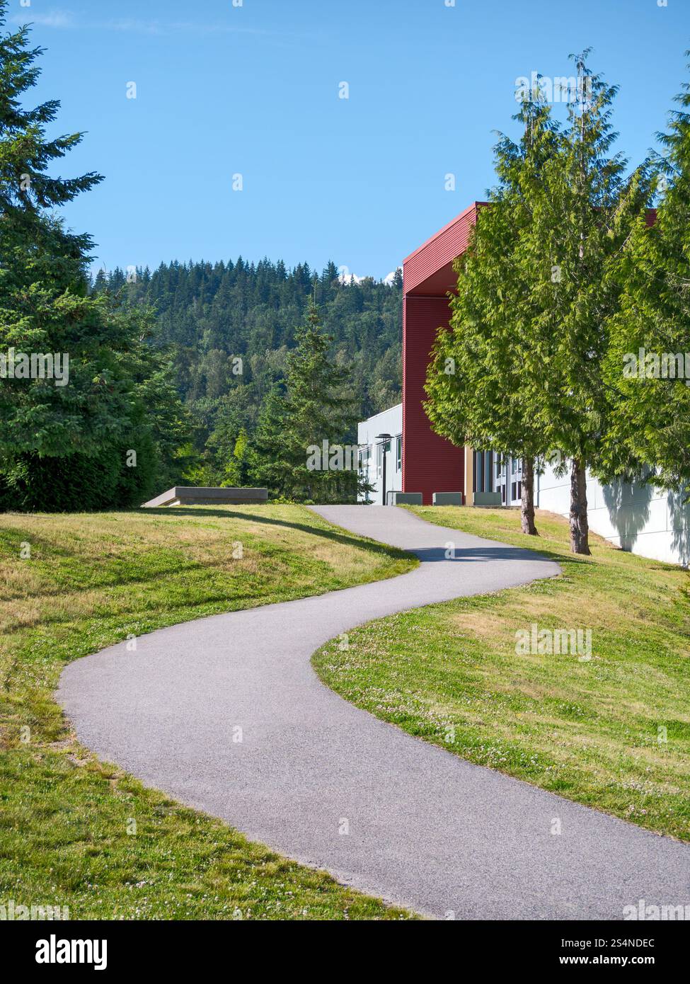 A winding path on the slope leading to an office building Stock Photo ...
