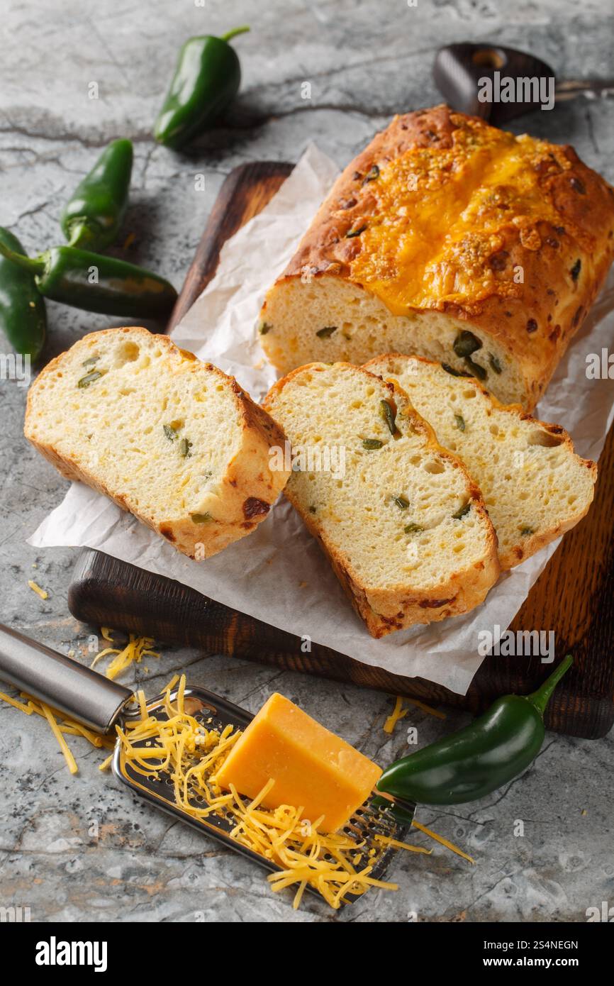 Rustic homemade bread with jalapeno peppers and cheddar cheese closeup ...