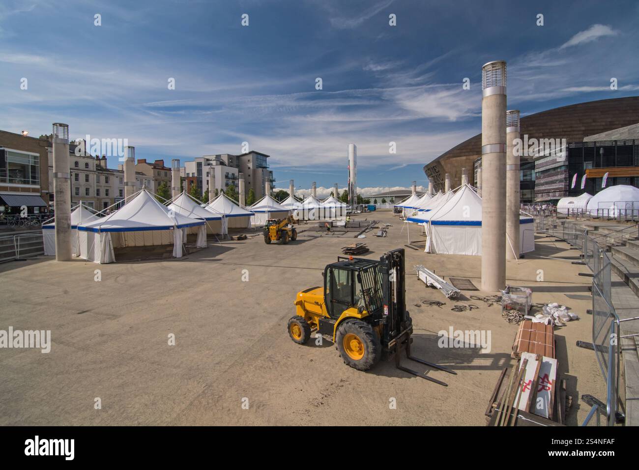 Workmen setting up static tents for a public festival in Cardiff Stock ...