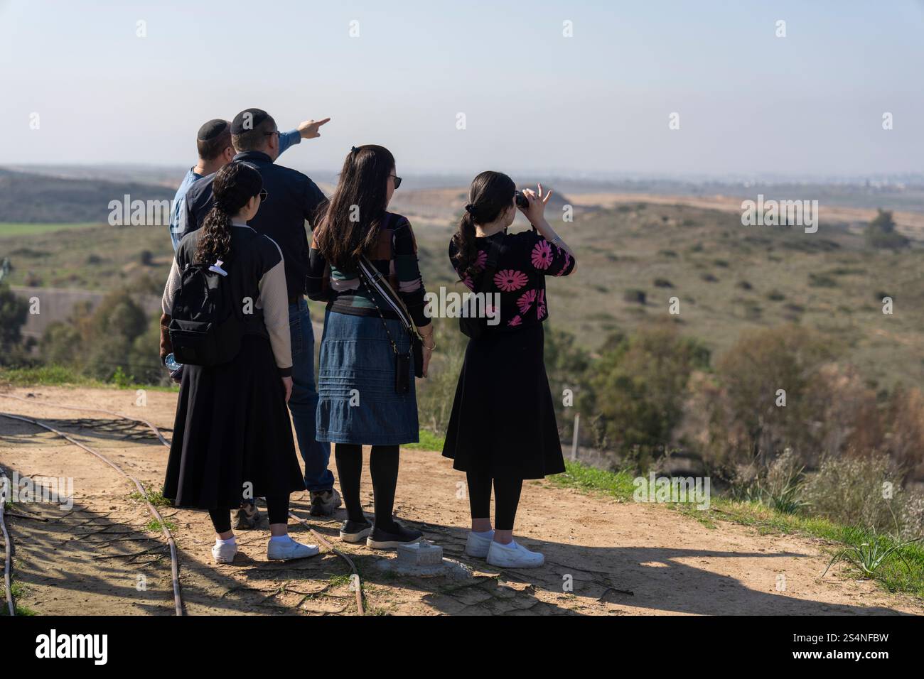 People watch the Gaza Strip from an observation point in Sderot ...