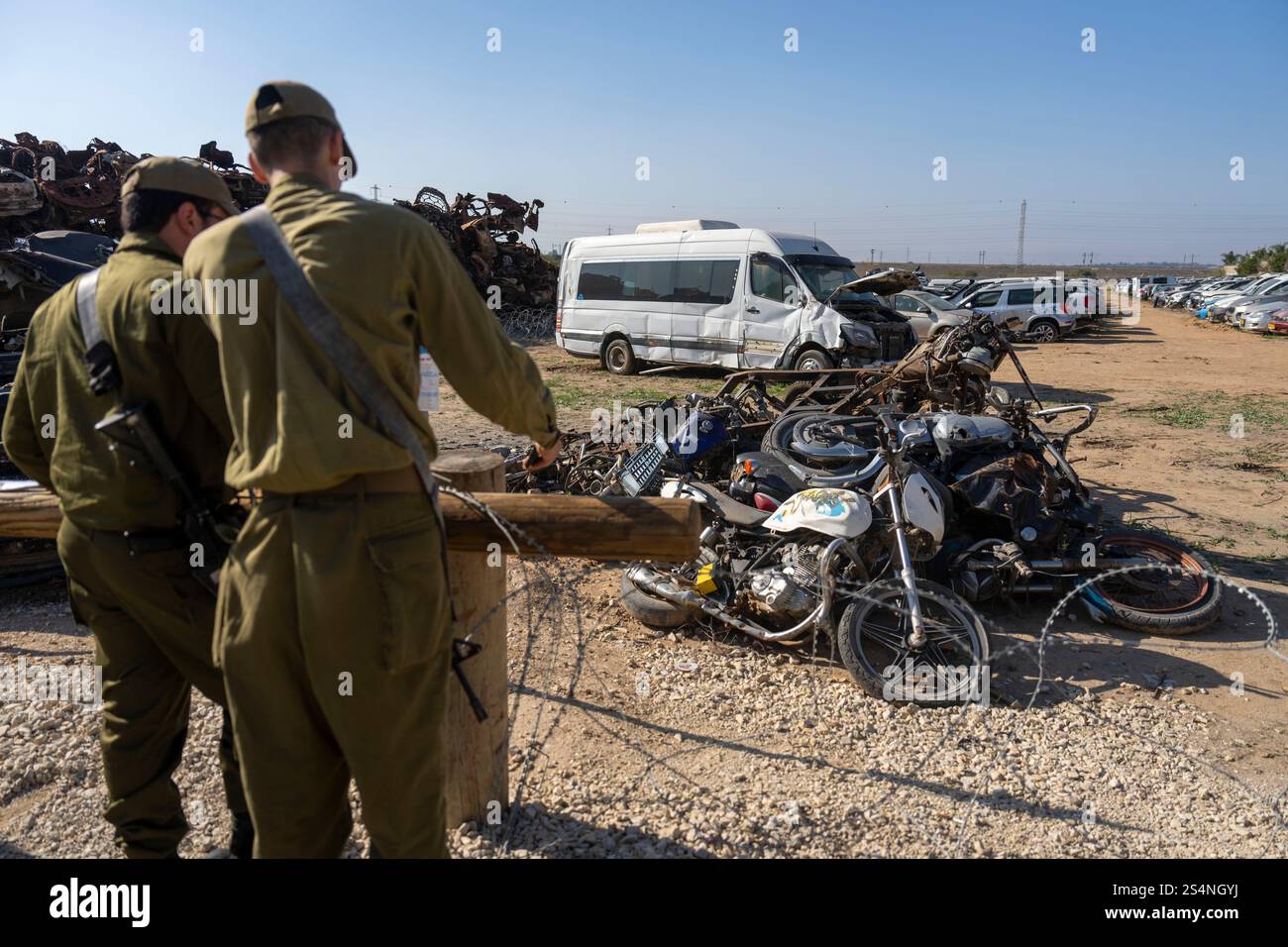 Israeli soldiers look at destroyed motorcycles outside the town of ...