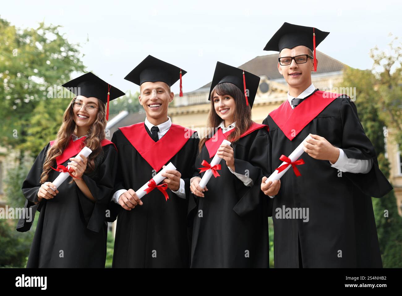 Happy students with diplomas after graduation ceremony outdoors Stock ...
