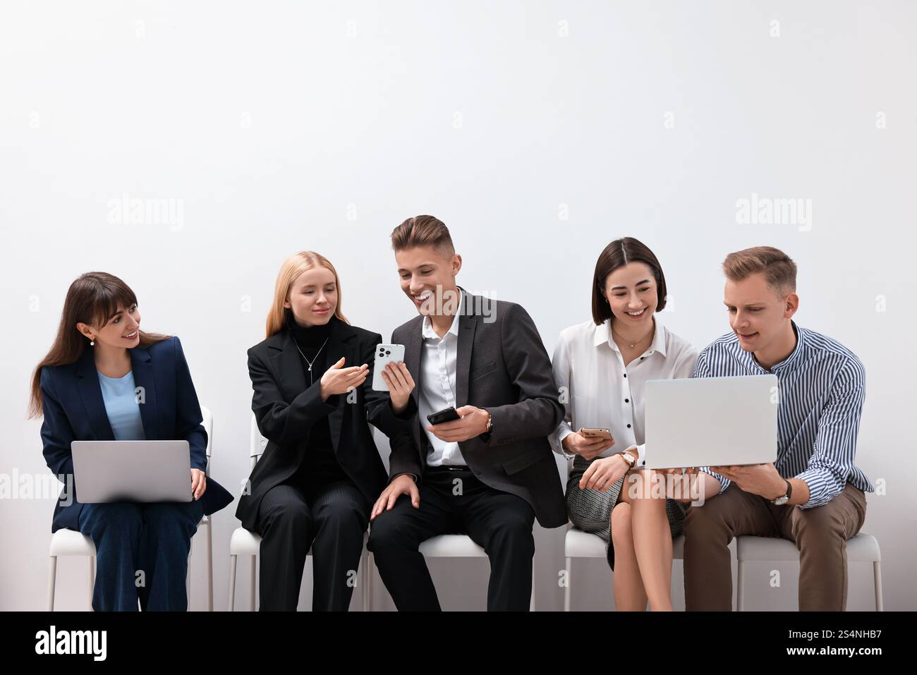 Group of people using different gadgets indoors. Modern technology ...