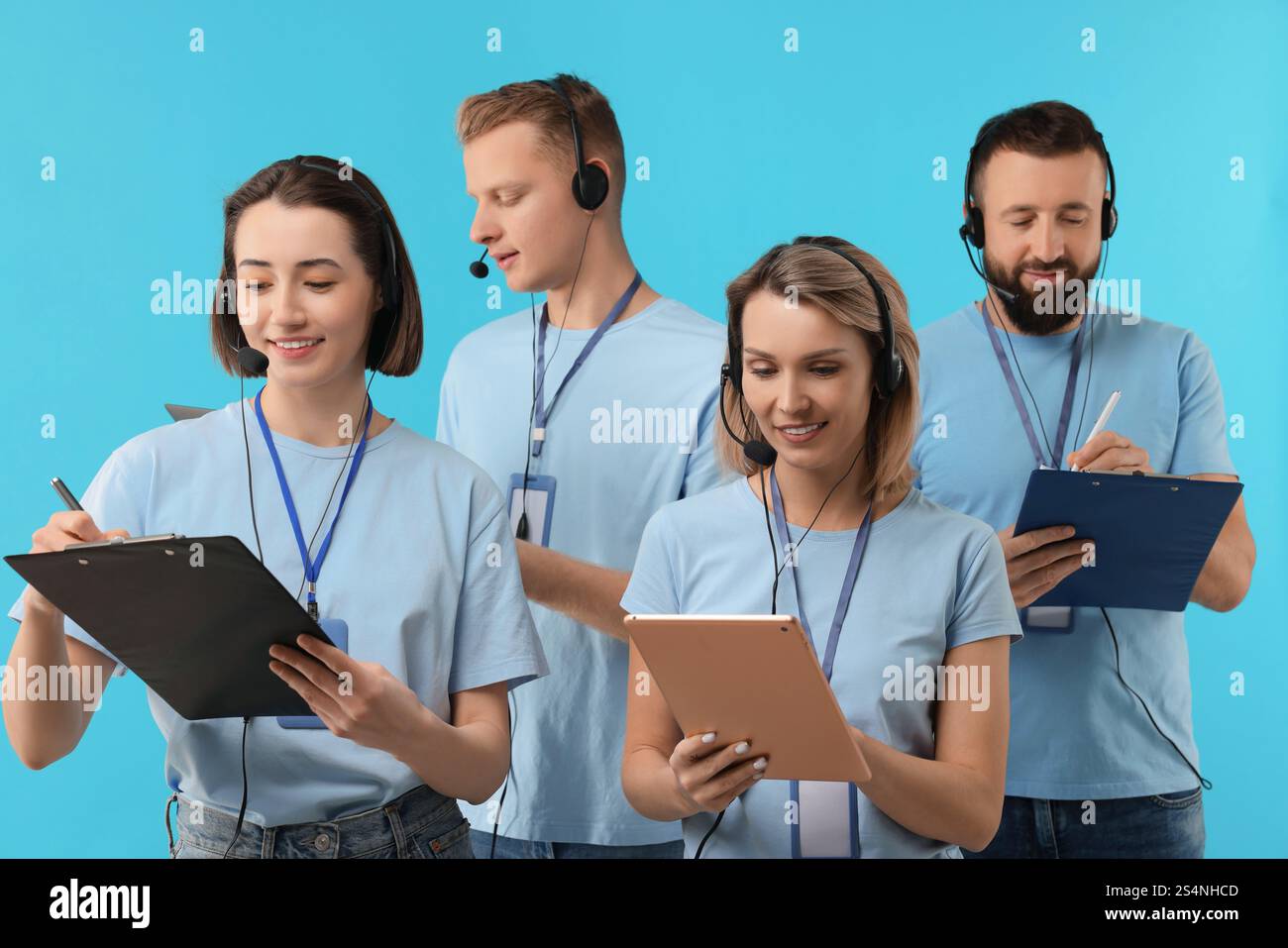 Technical support call center. Team of friendly operators working on ...