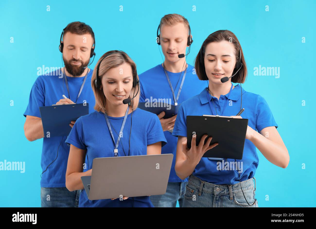 Technical support call center. Team of friendly operators working on ...