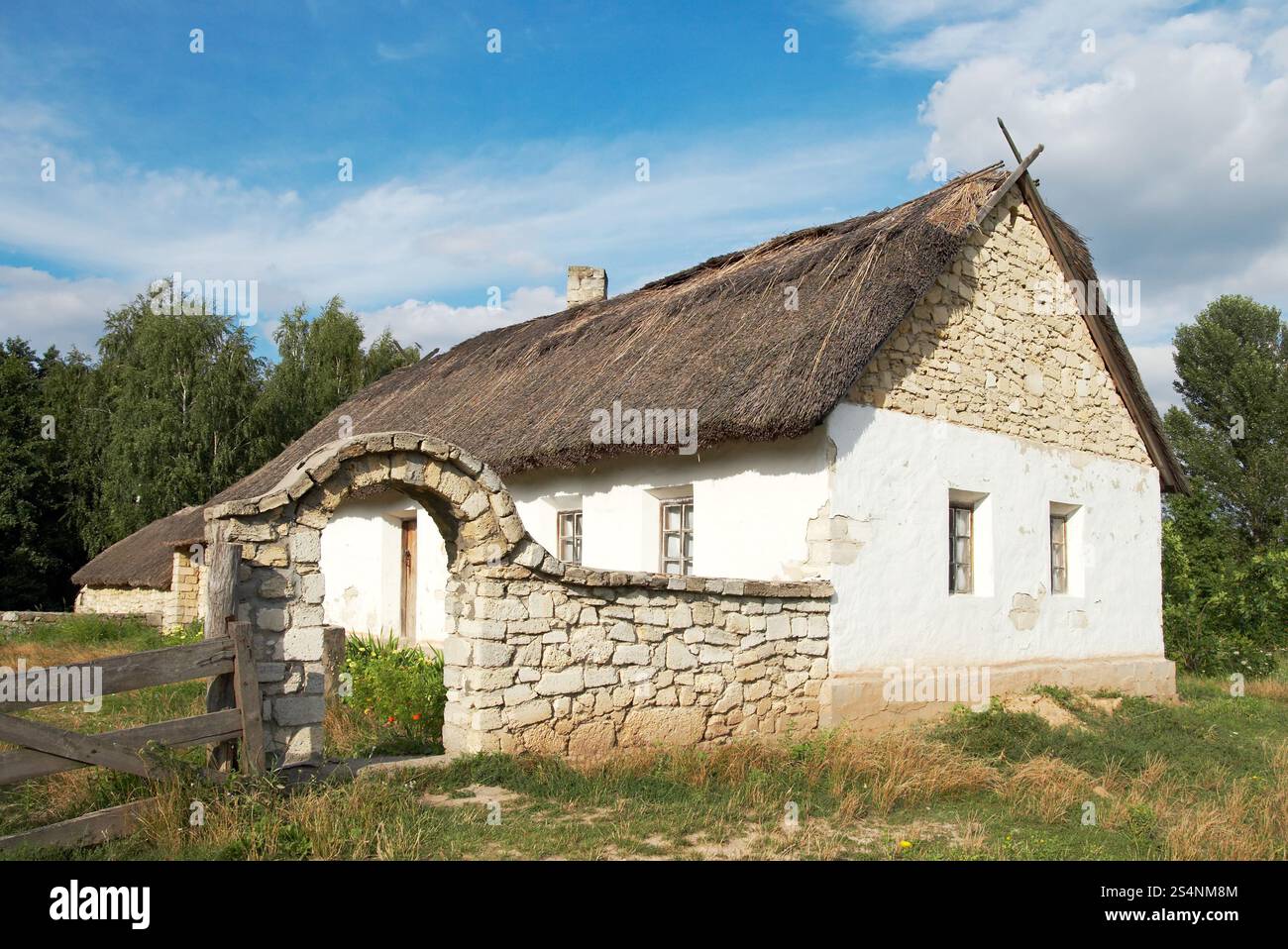 historical country farmstead with stone fence and arc (preceding ...