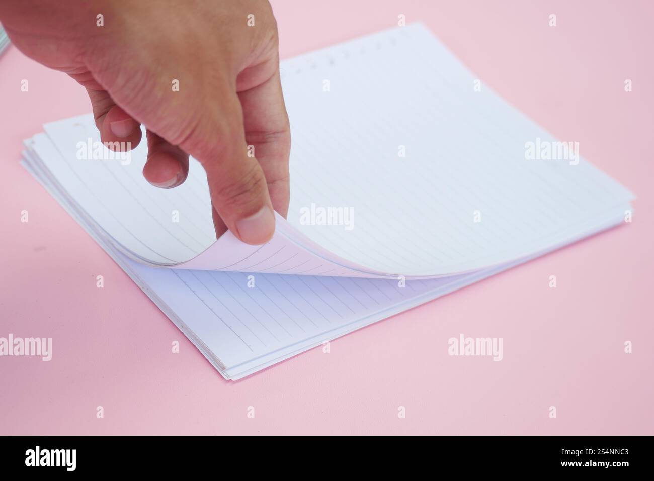 hand flipping blank white paper on pink background Stock Photo - Alamy