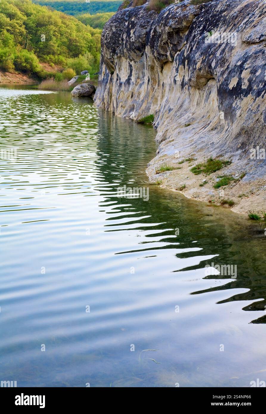beautiful lake with spring rocky bank reflection in water surface Stock ...