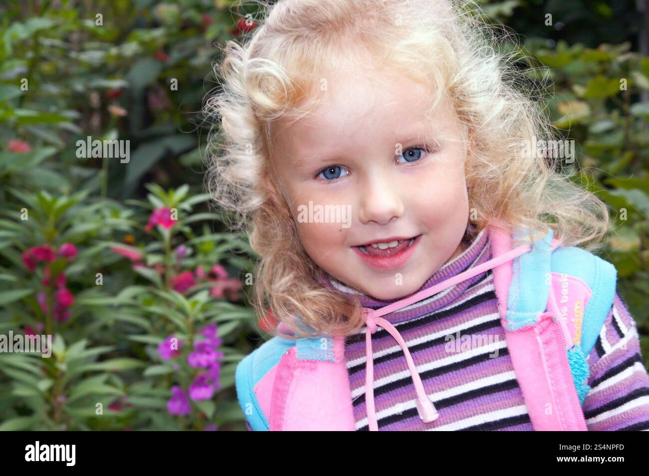 mischievous mistrustful little girl in ornamental garden Stock Photo ...