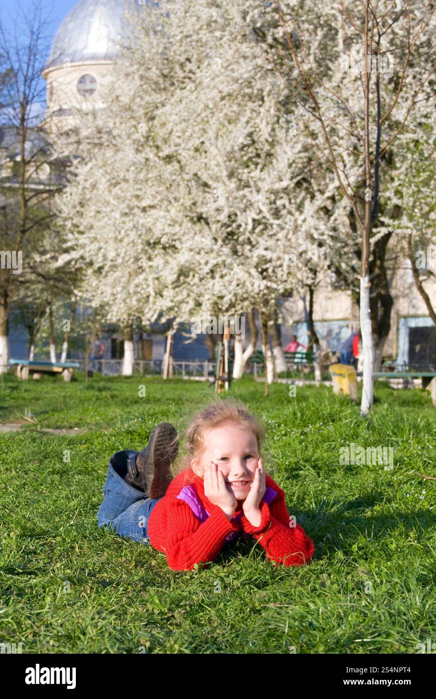 Happy small girl in spring recreation ground Stock Photo - Alamy