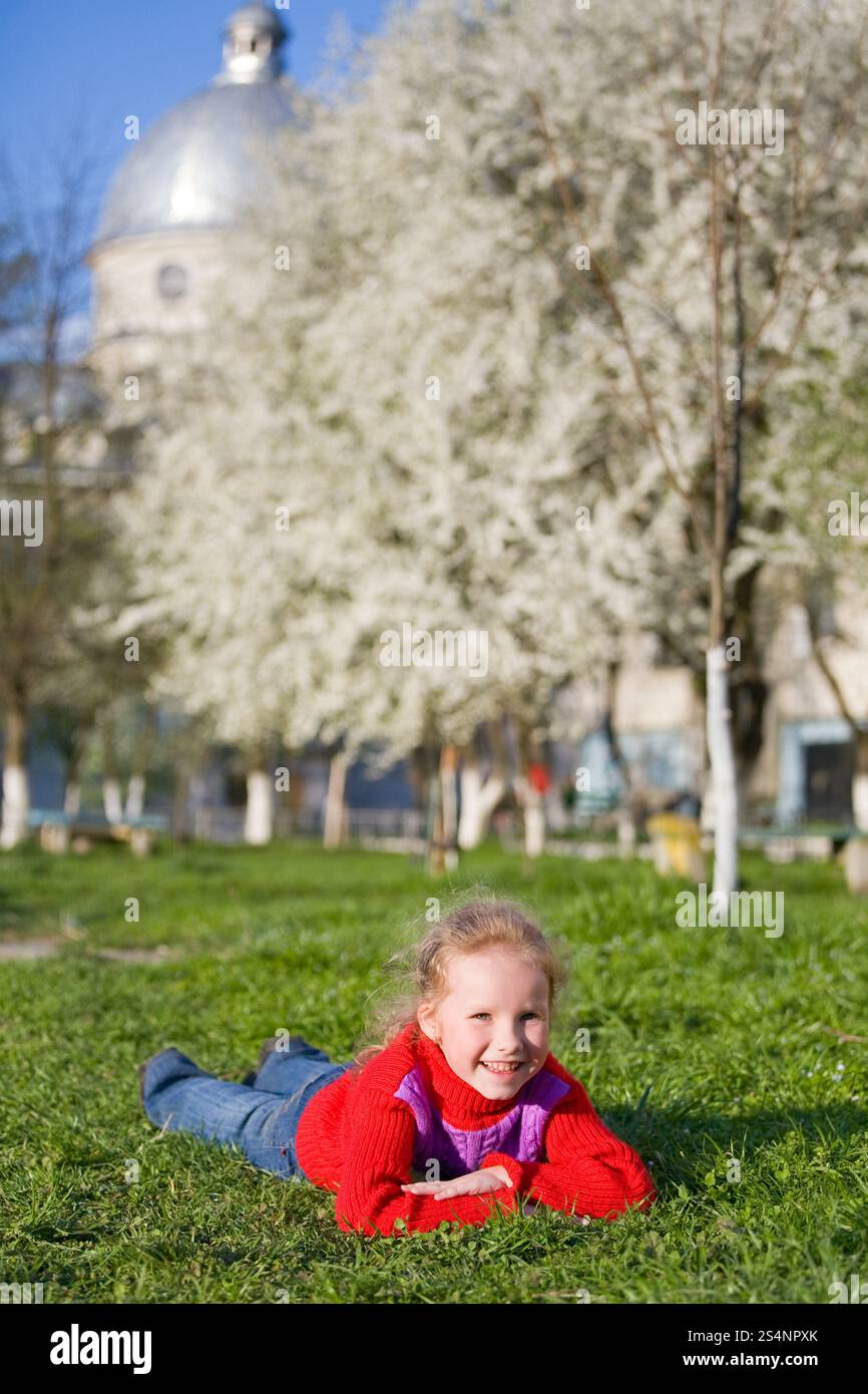 Happy small girl in spring recreation ground Stock Photo - Alamy
