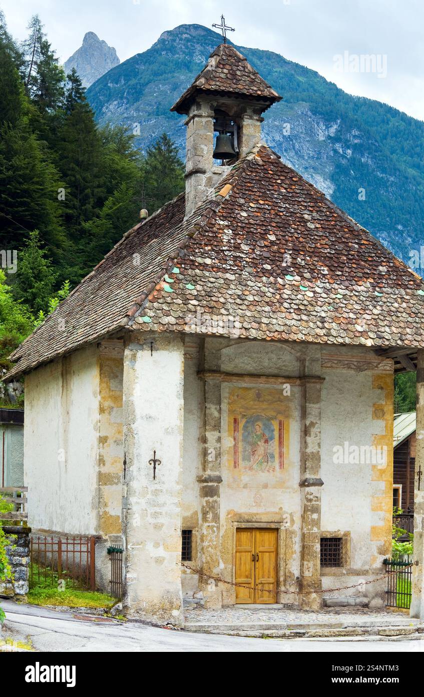 Tranquil summer Italian dolomites mountain and village old chapel ...