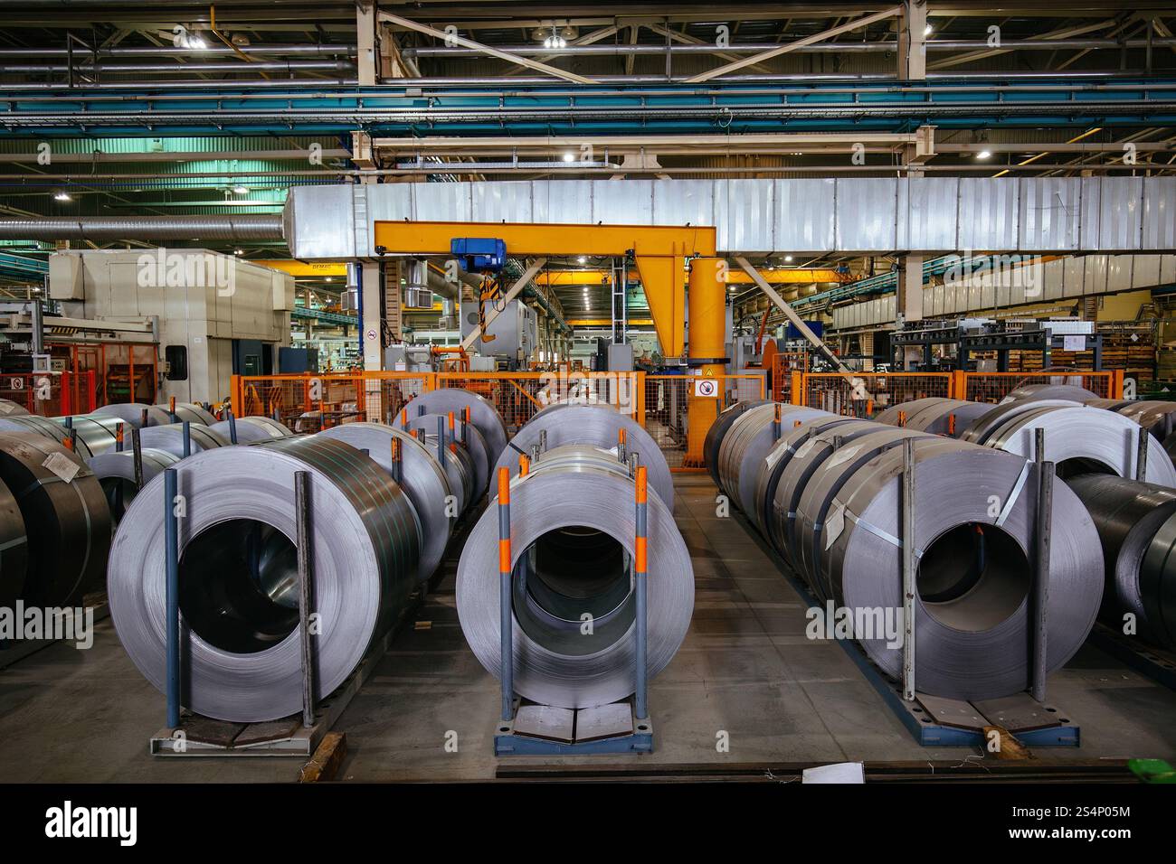 Rolls of perforated galvanized steel sheet in metalworking factory ...