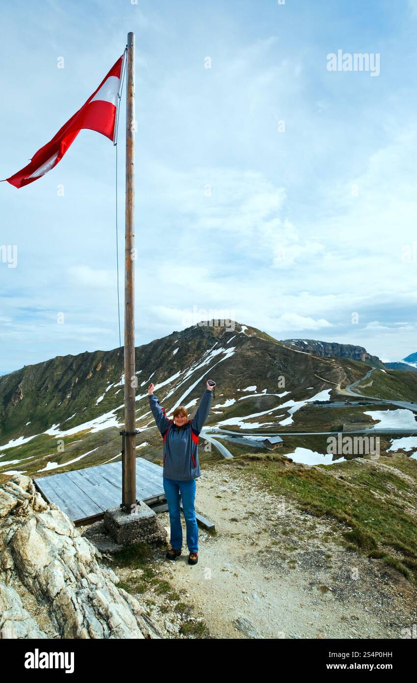 Austrian Flag above Alps mountain (Grossglockner High Alpine Road) and ...