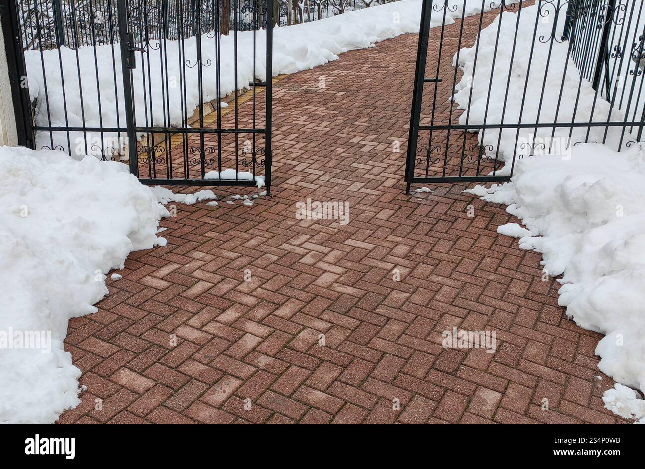 Winter Pathway: Pavement and Metal Door Frame Stock Photo - Alamy