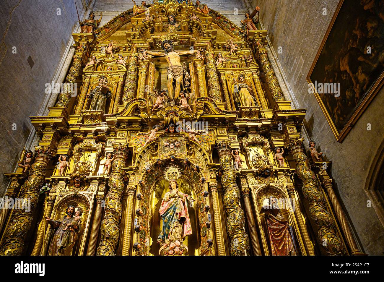 Golden altar adorned with Catholic icons and symbols inside the famous religious landmark Stock ...