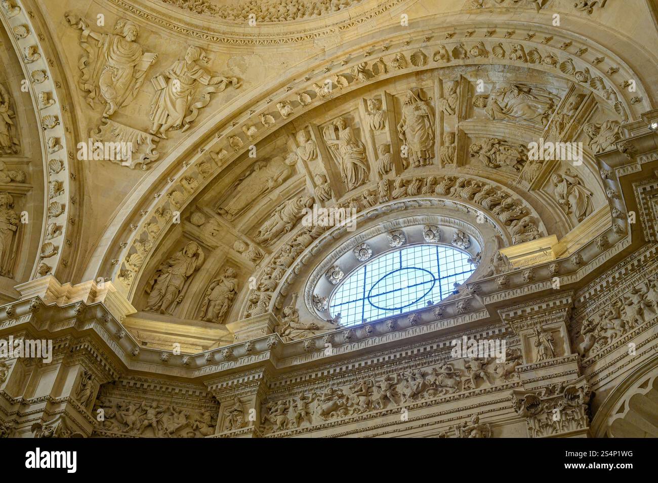 Ancient interior wall with a skylight window, featuring complex bas ...